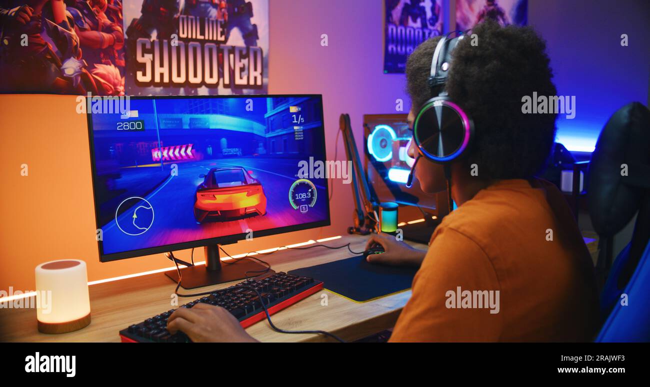 African American guy, teenage gamer in headphones plays in online 3D ...