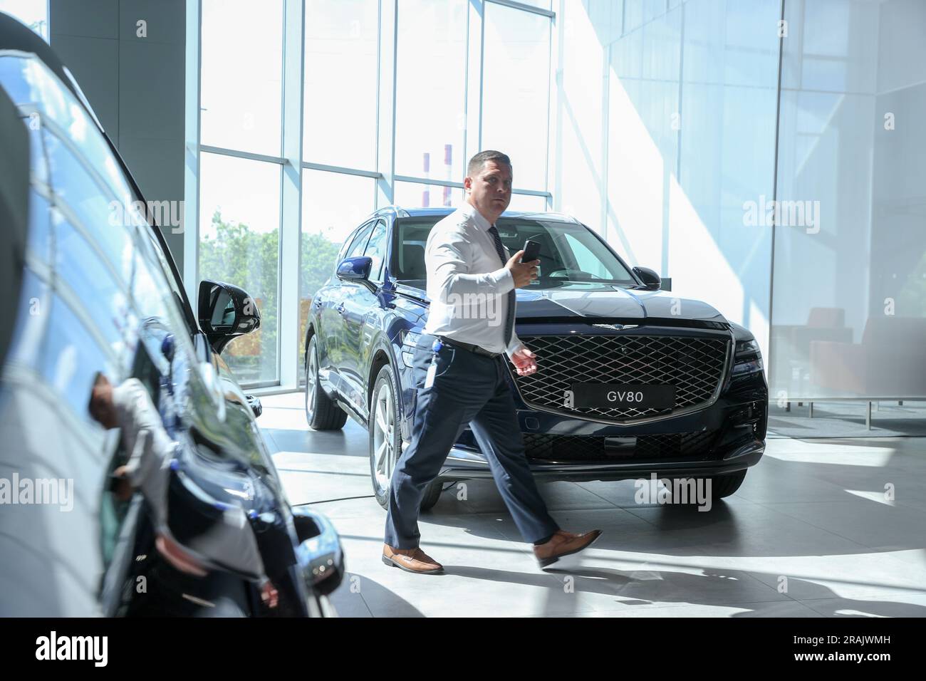 Russia. Moscow. The manager of the car dealership near the Genesis car ...