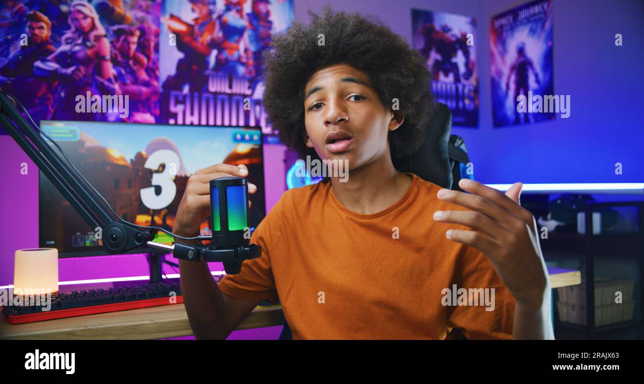 African American teenage gamer, blogger speaks on camera using ...