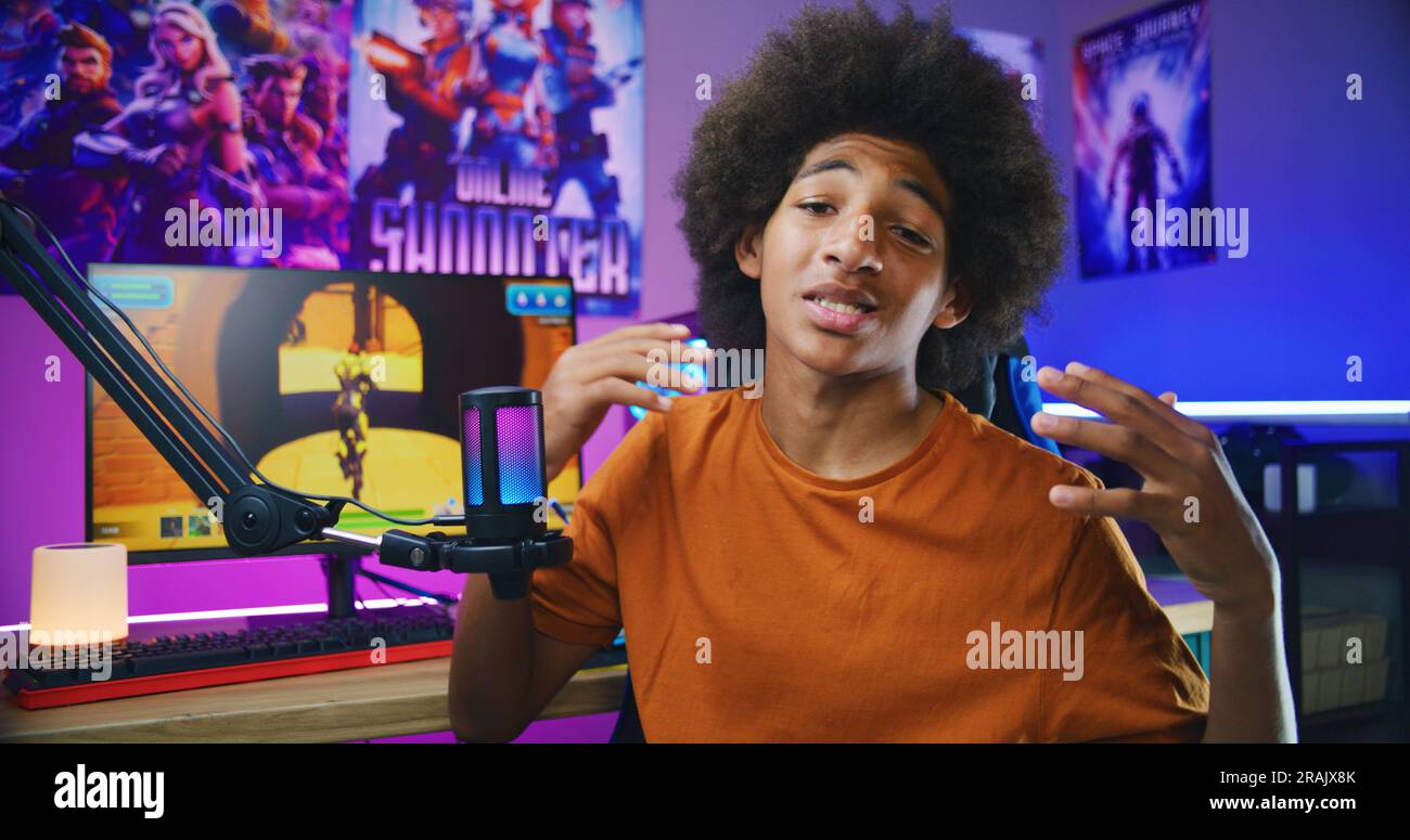 African American teenage gamer, blogger speaks on camera using ...