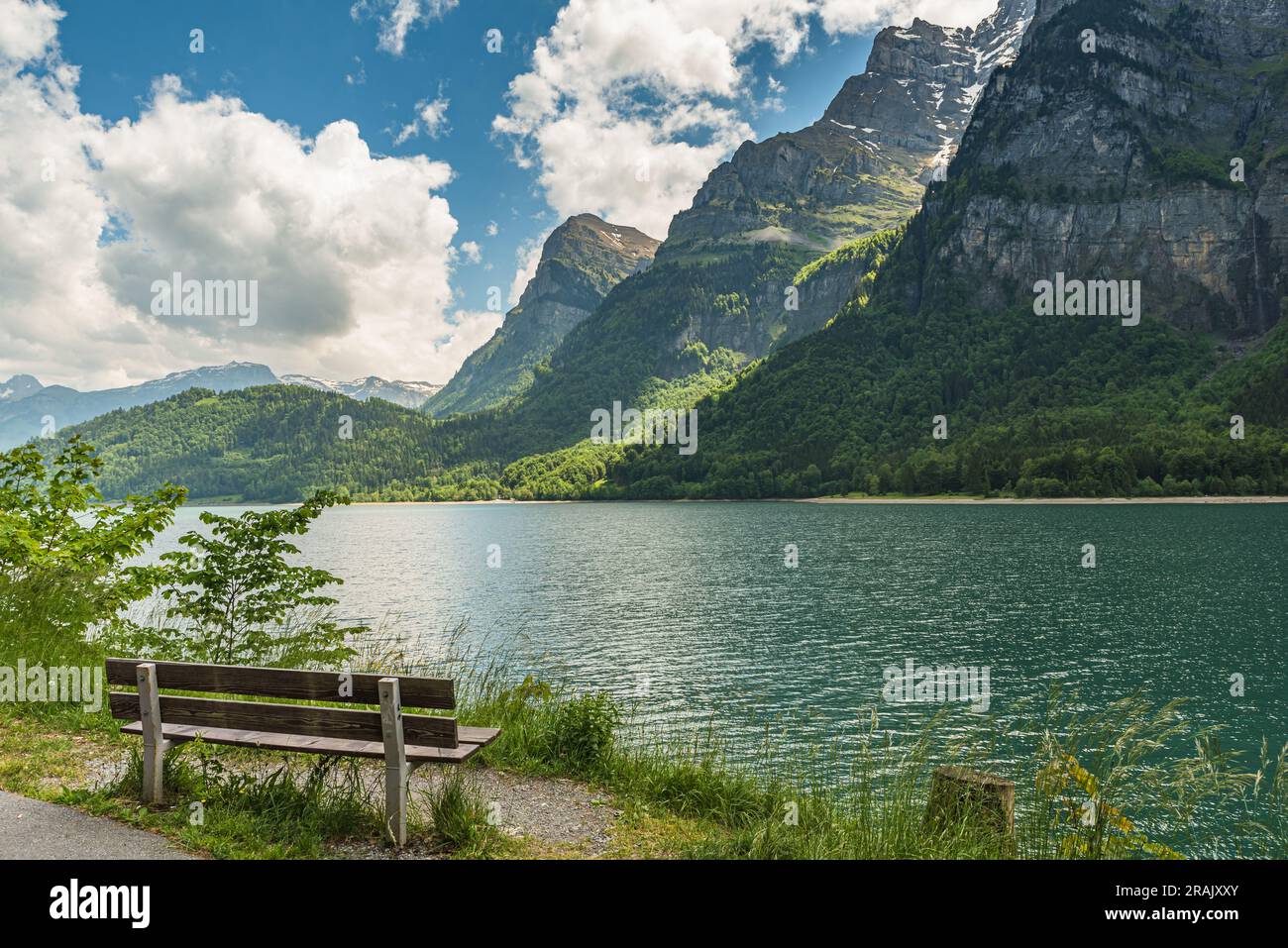 Bench on the shore with idyllic view of Lake Kloentalersee, Kloental ...