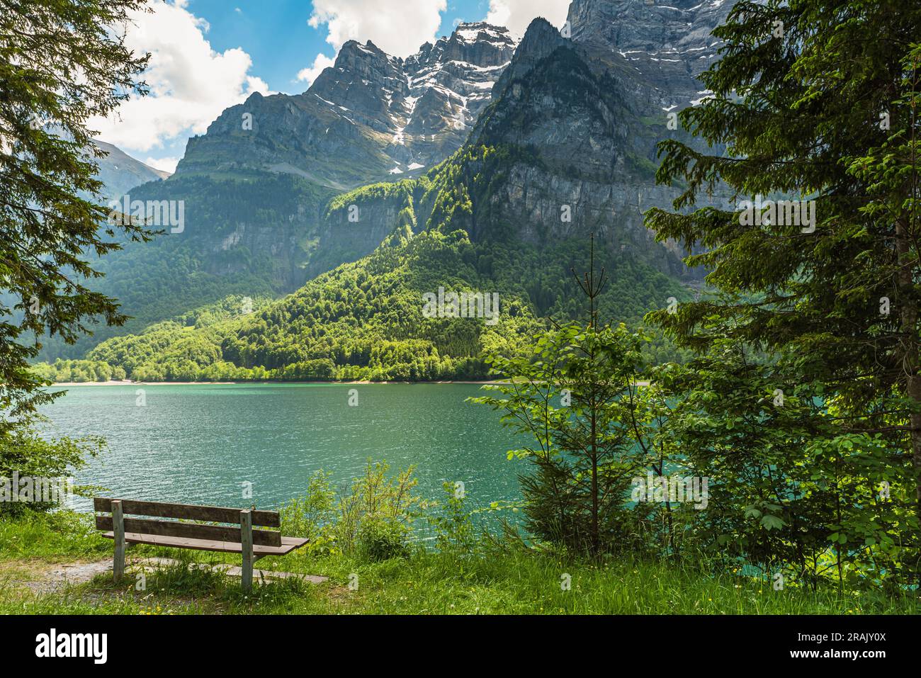 Bench on the shore with idyllic view of Lake Kloentalersee, Kloental ...