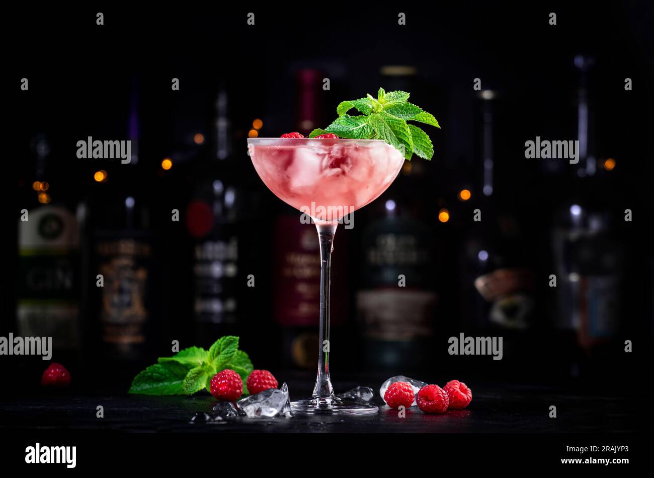 Raspberry daiquiri alcoholic cocktail with white rum, sugar syrup, fruit juice, lime, berry and ...