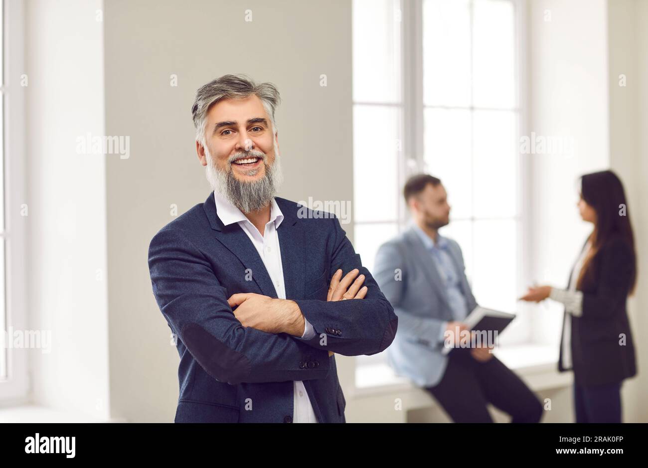 Handsome businessman folded arms hi-res stock photography and images ...