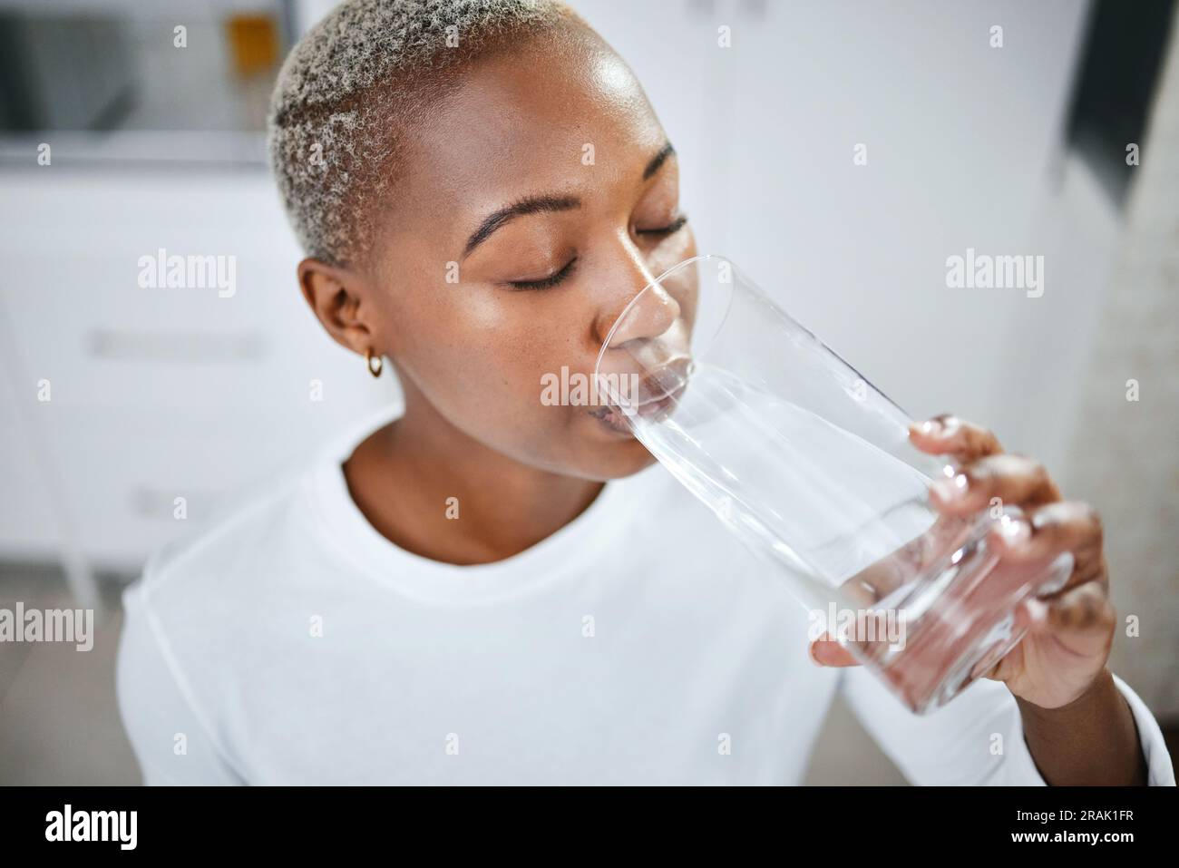 Health, glass and woman drinking water for hydration, wellness and ...