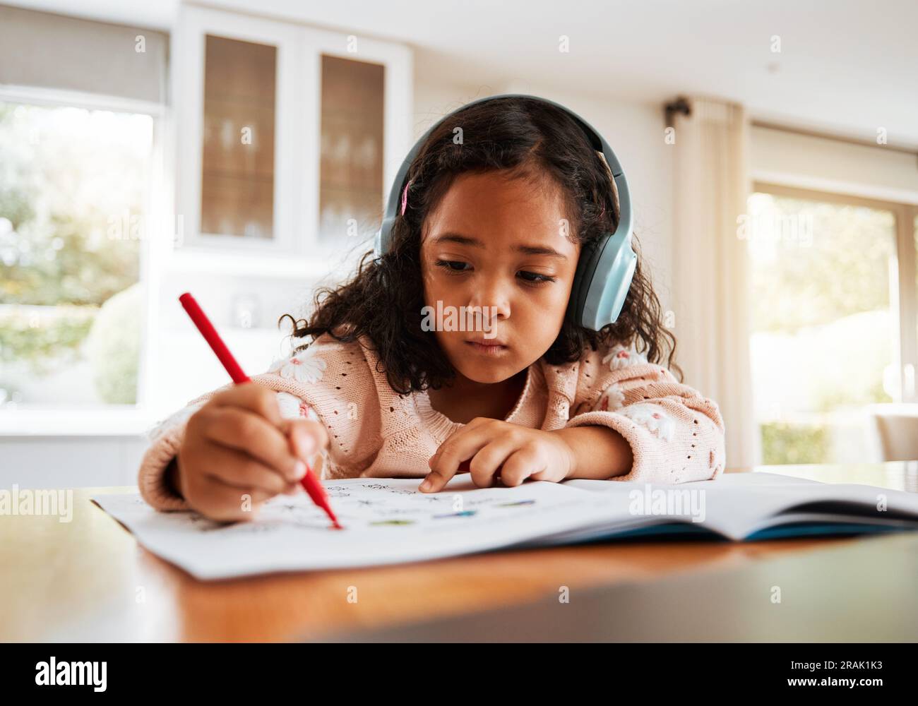 Education, learning or headphones on kid for homework, writing and ...