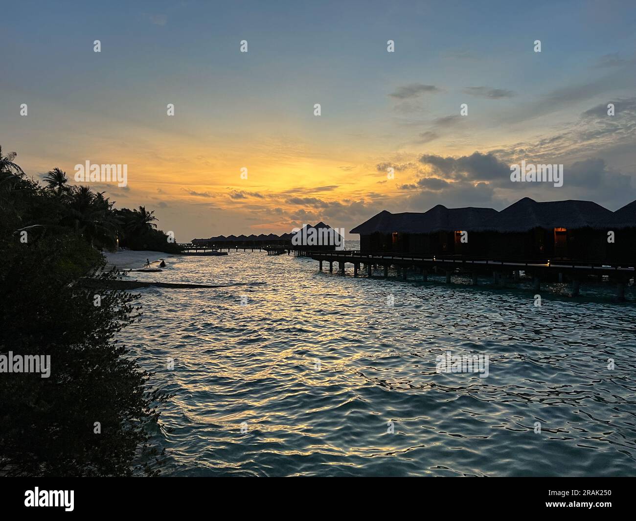 gorgeous view of the water villas in silhouette with a dramatic sky ...