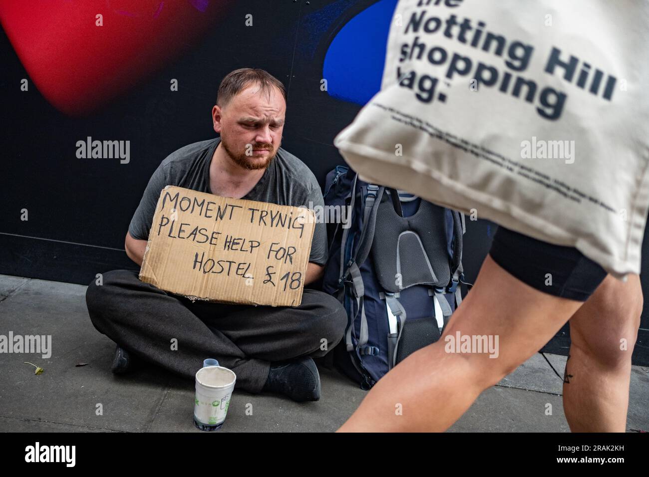 London- June 2023: A homeless person sitting on the street on Oxford ...