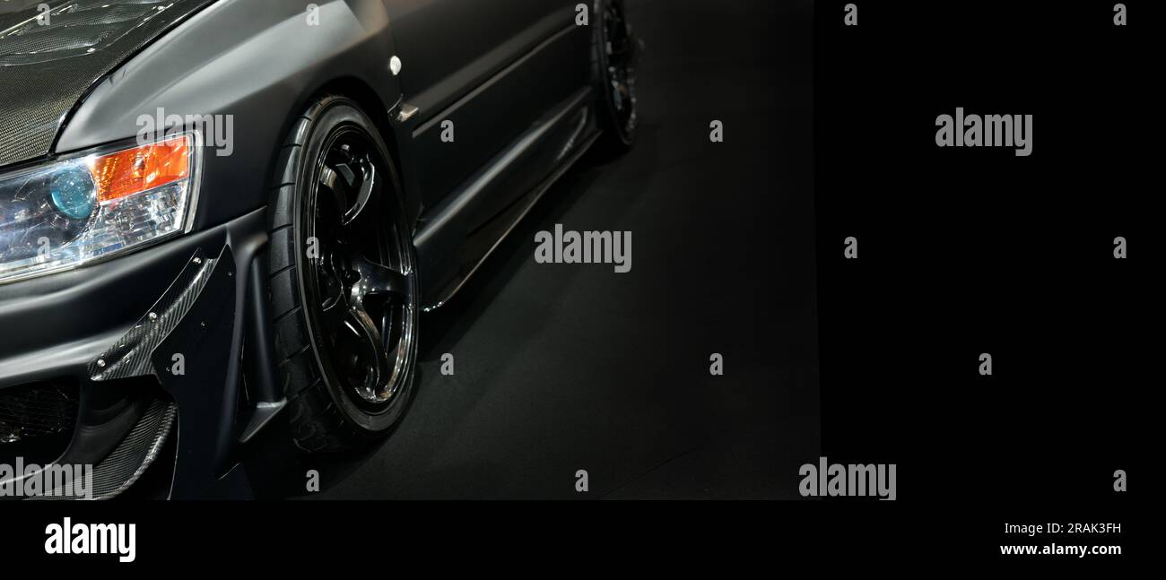 Front headlights of black modify car on black background, copy space ...