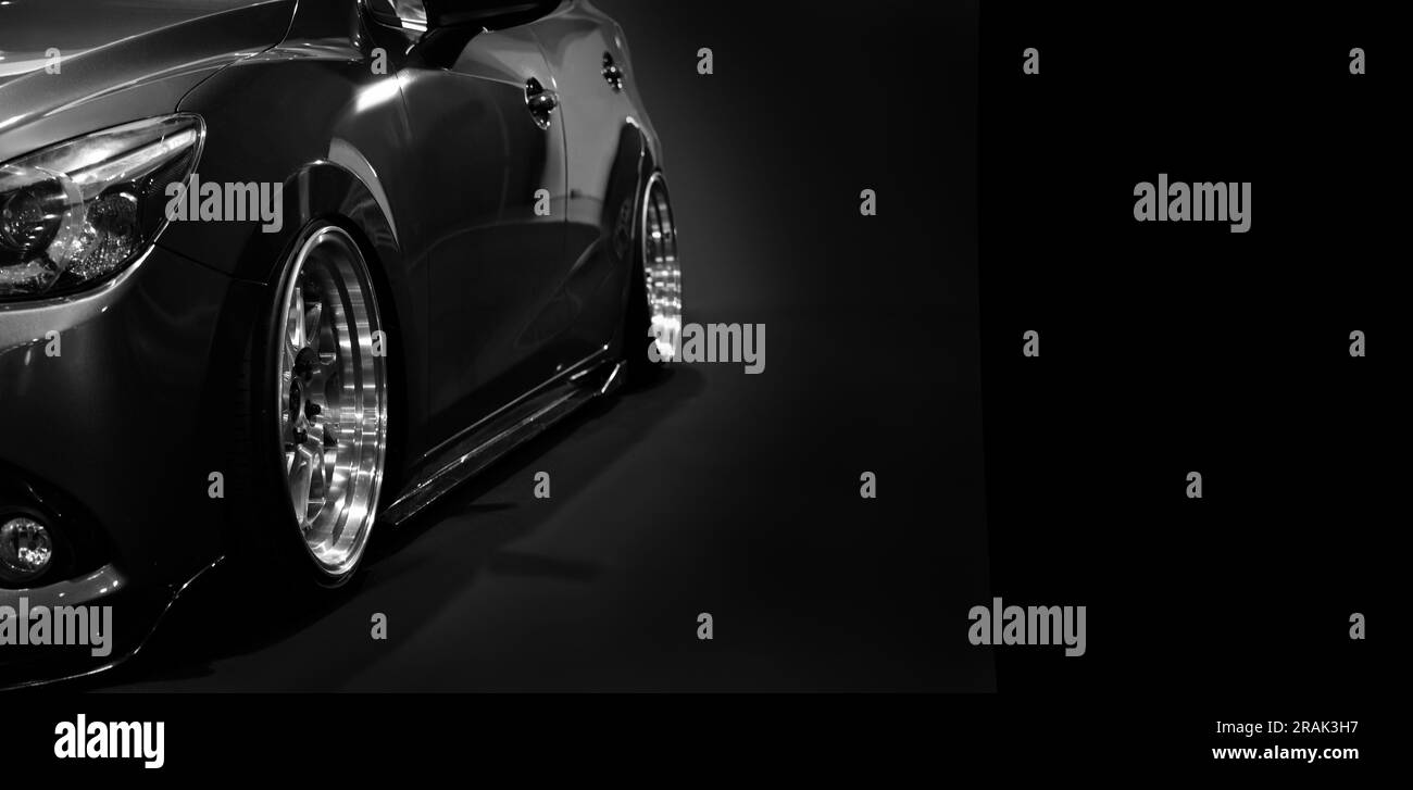 Front headlights of black modify car on black background, copy space ...
