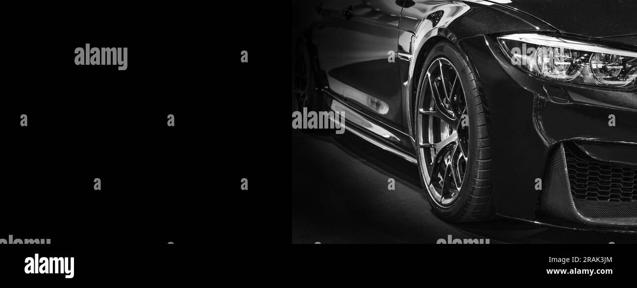 Front headlights of black modify car on black background, copy space ...