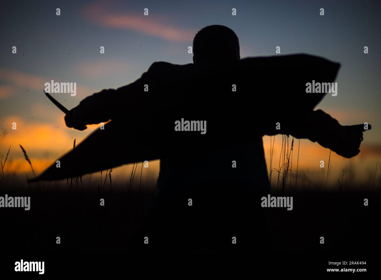 Demon and vampire hunter silhouette is fighting. A man with a katana ...