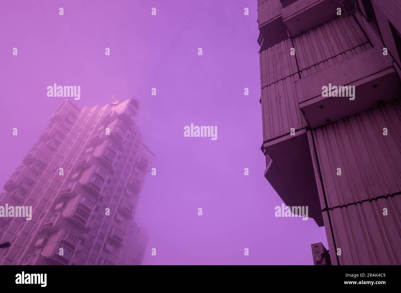 Tall residential buildings in the form of a tower, immersed in a misty ...