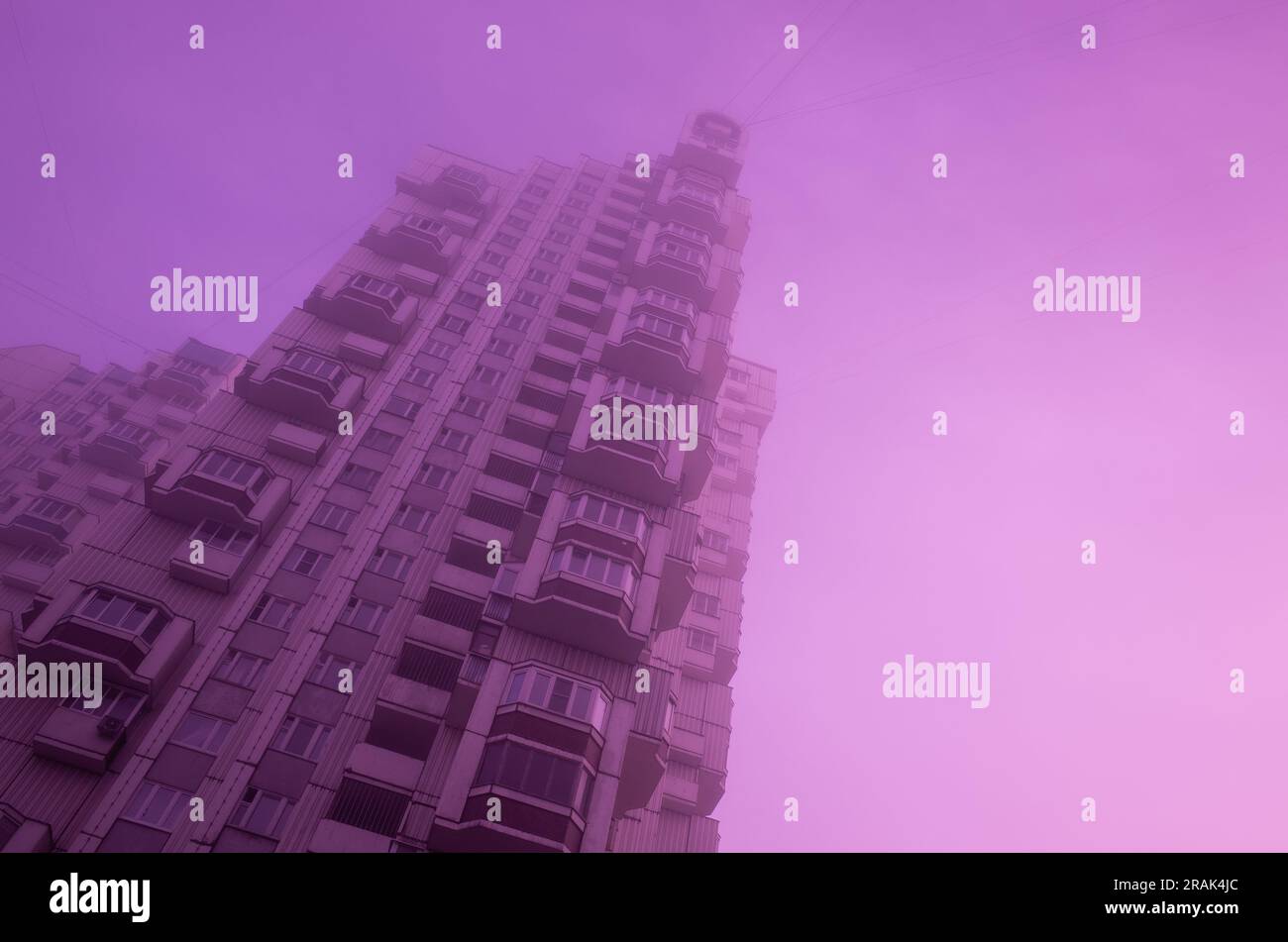 Tall residential buildings in the form of a tower, immersed in a misty ...