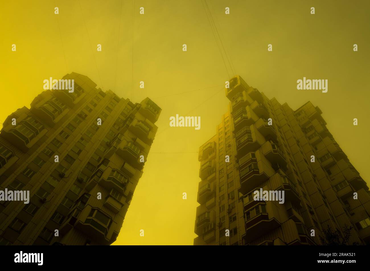 Tall residential buildings in the form of a tower, immersed in a misty ...