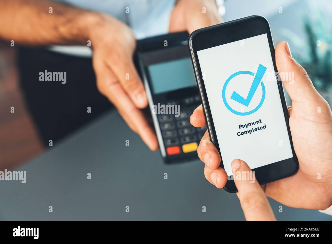 Hand holding smartphone with NFC QR code device, scanning contactless ...