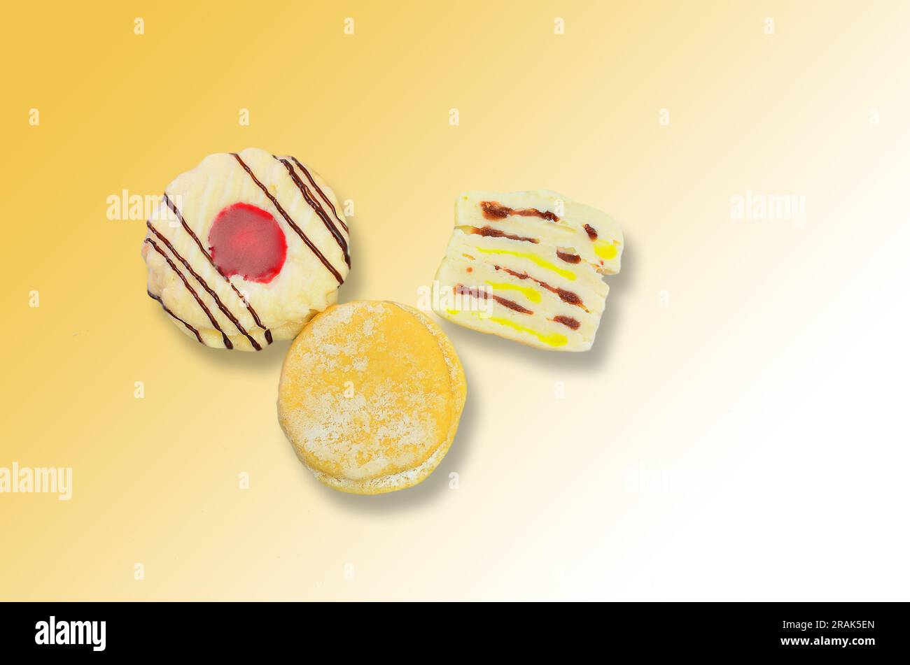 three different biscuits on ocher background with colour gradient ...