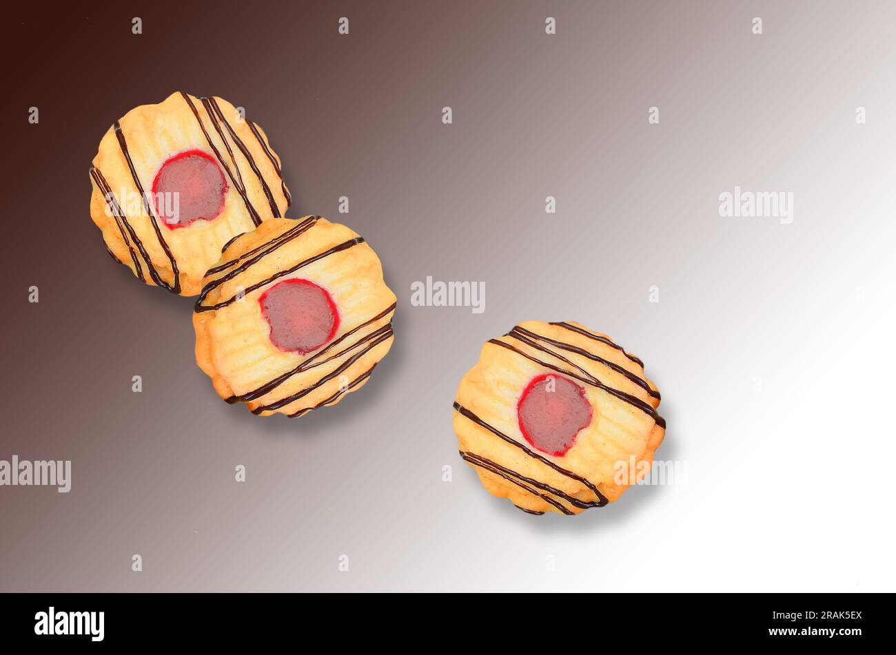 three biscuits on brown background with colour gradient, close up Stock ...