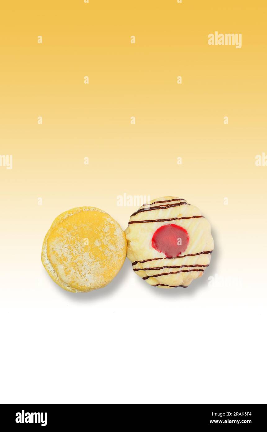 two different biscuits on ocher background with colour gradient, close ...
