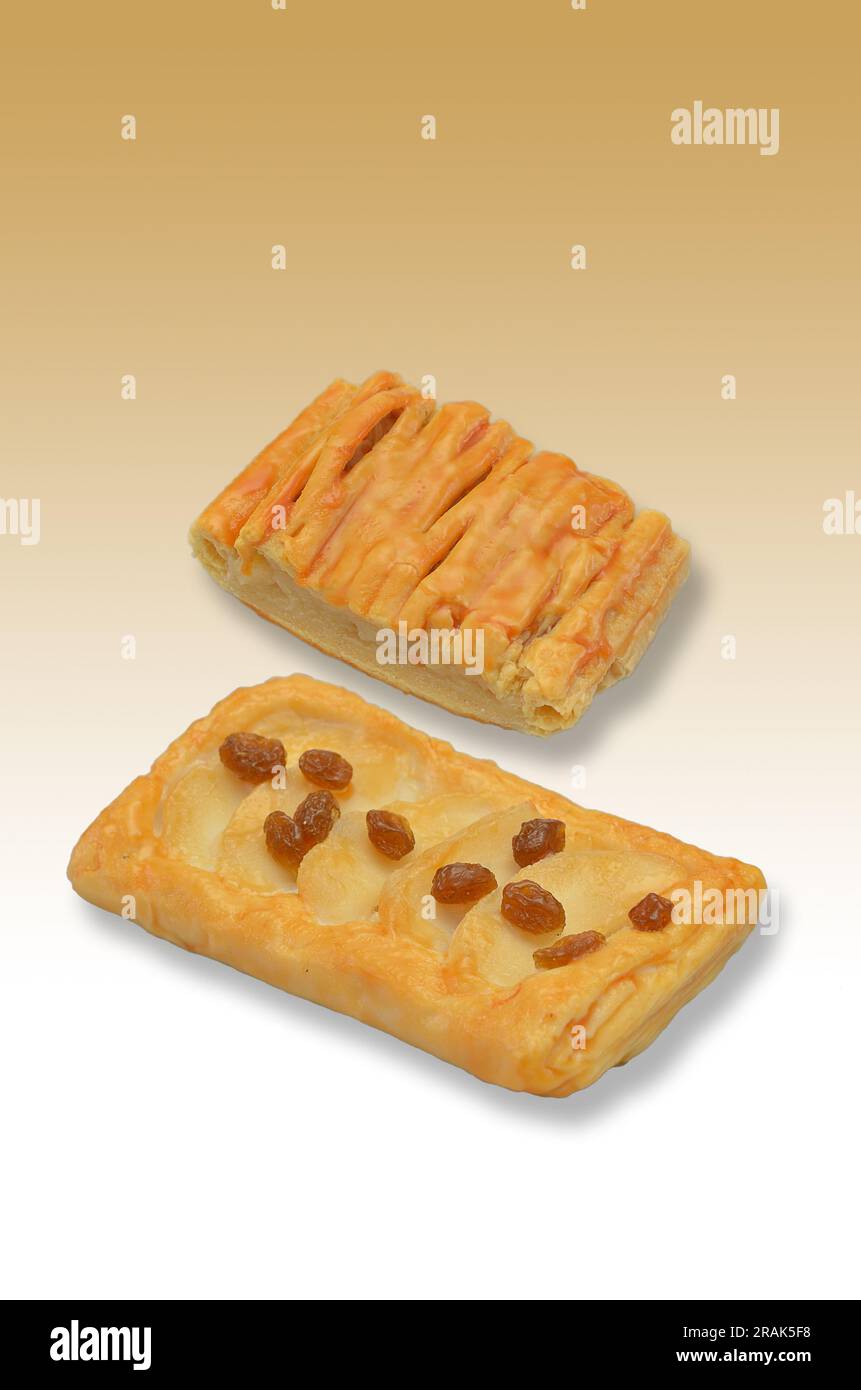 two pieces of apple pie on light brown background with colour gradient ...