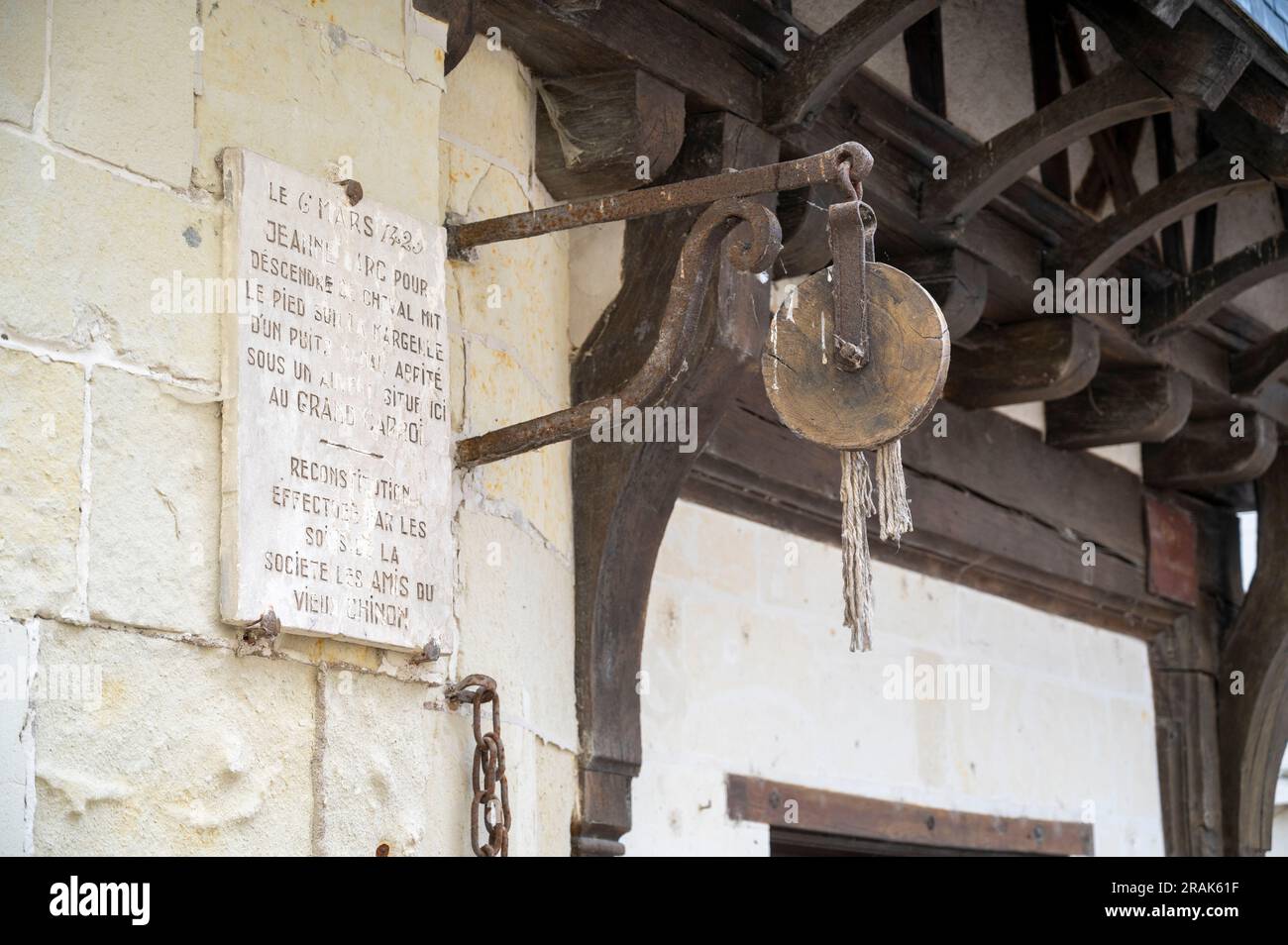 An old wooden pully or hoist ona medieval buildlng in Chinon Loire ...