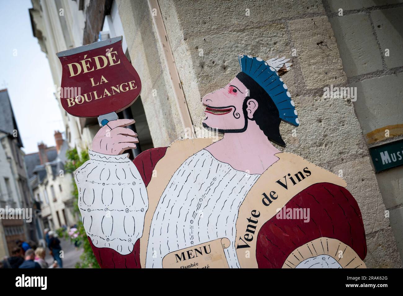 A sign with a model of a medieval man advertising wines for sale in ...