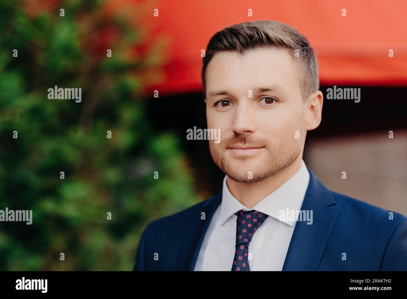 Attractive manager, confident gaze, formal attire; poses outside ...