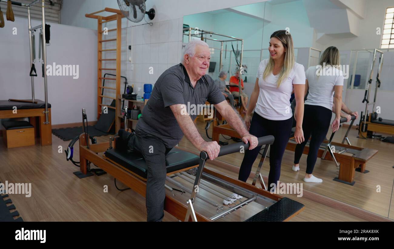 Elderly Man in Spine Workout Routine, Pilates Studio Session Coached by ...