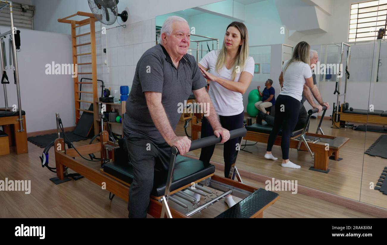 Elderly Man in Spine Workout Routine, Pilates Studio Session Coached by ...
