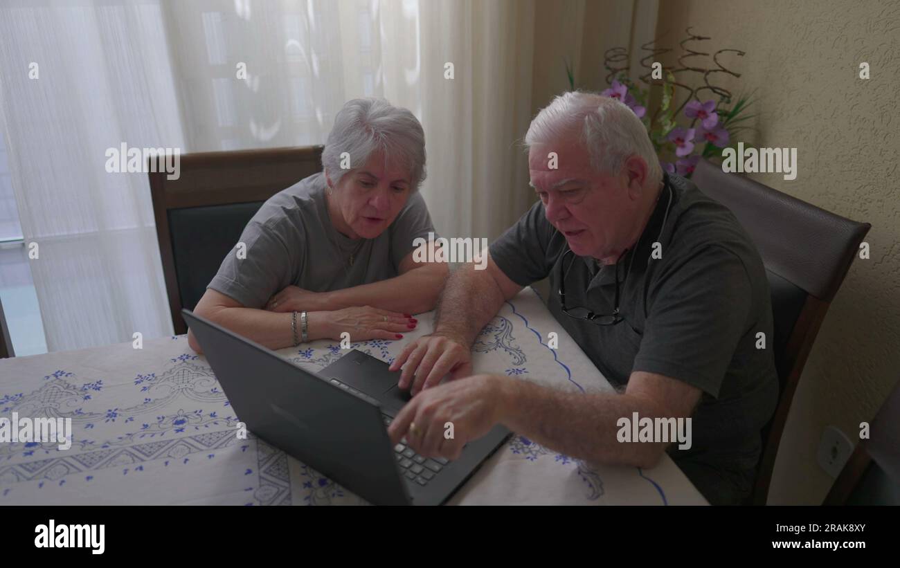 Elderly couple using laptop at home, old age and modern technology ...