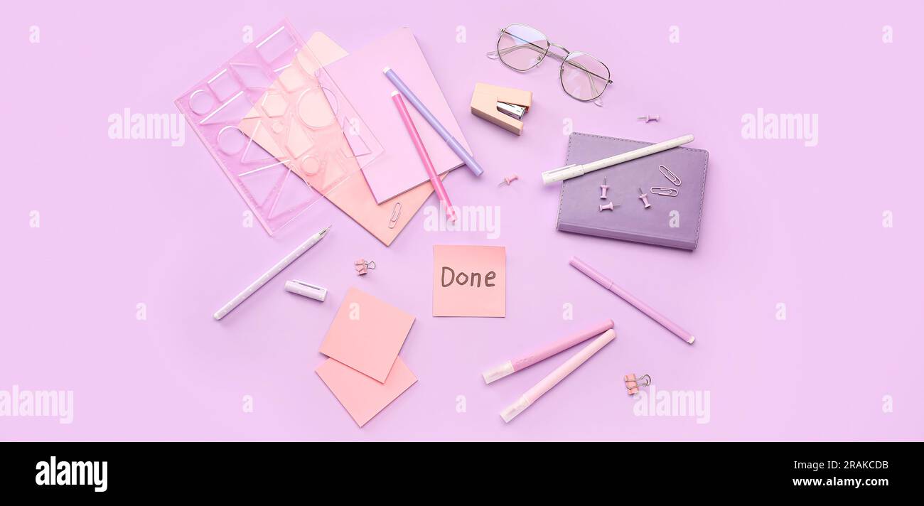 Sticky note with word DONE, eyeglasses and stationery on lilac ...