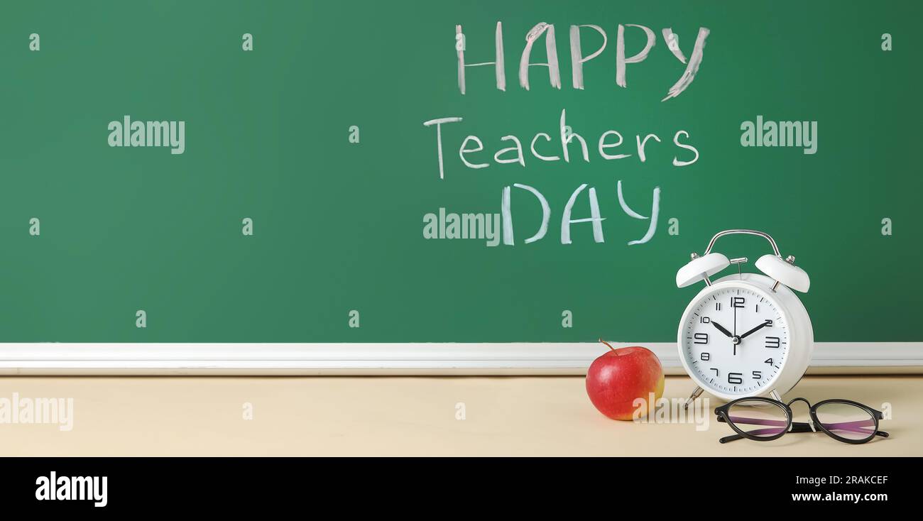 Text HAPPY TEACHERS DAY on green chalkboard, alarm clock, apple and ...