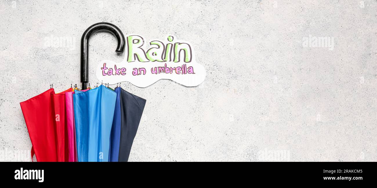 Paper with text RAIN. TAKE AN UMBRELLA on grunge background with space ...