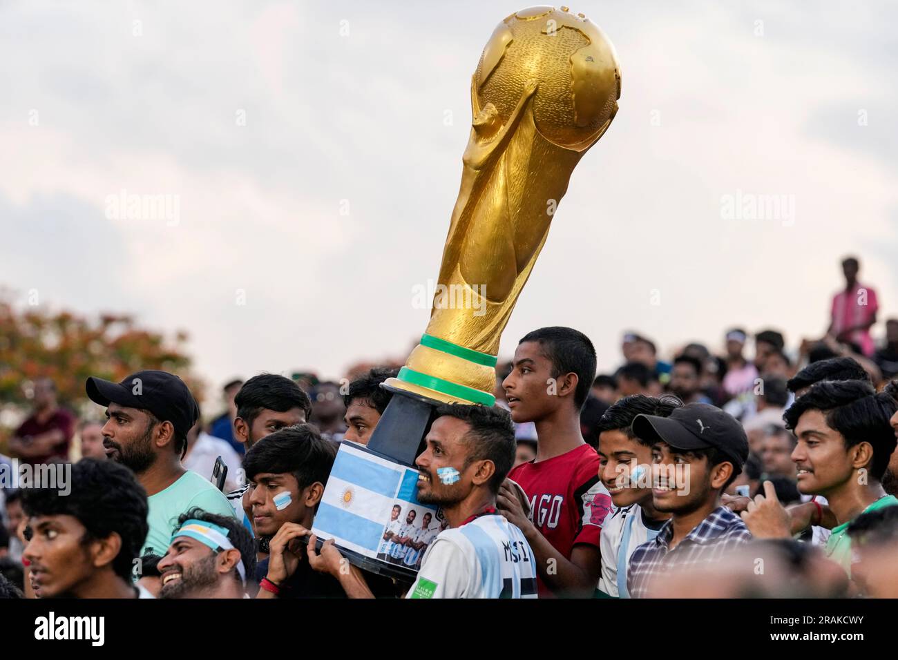 Indian soccer fans carrying a replica of FIFA World Cup cheer Argentina ...
