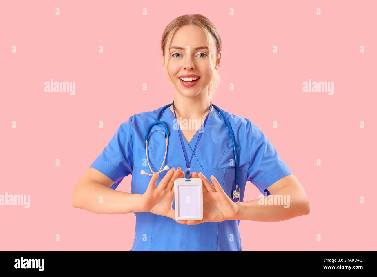 Female medical intern with badge on pink background Stock Photo - Alamy