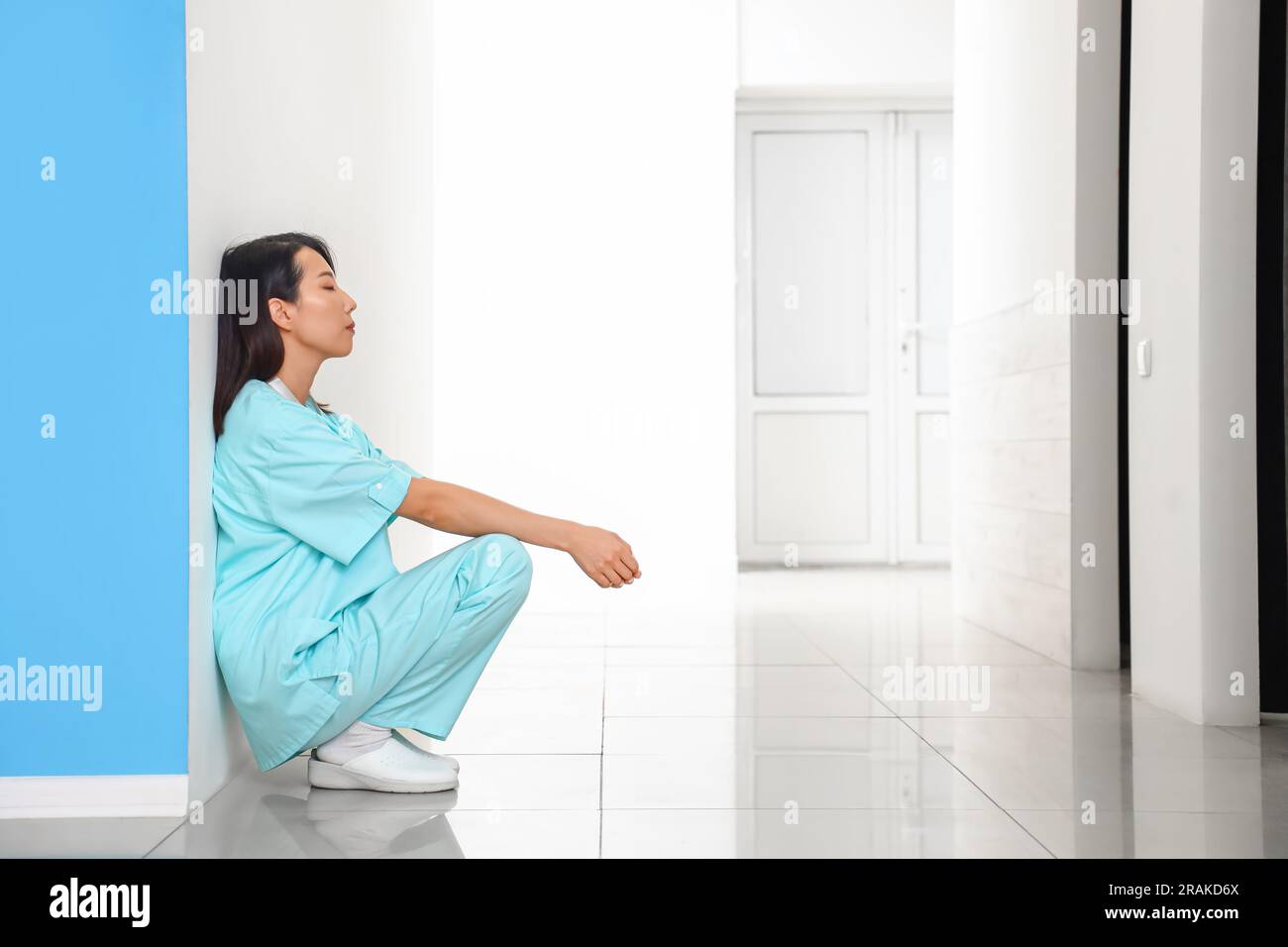 Stressed female Asian medical intern in clinic Stock Photo - Alamy