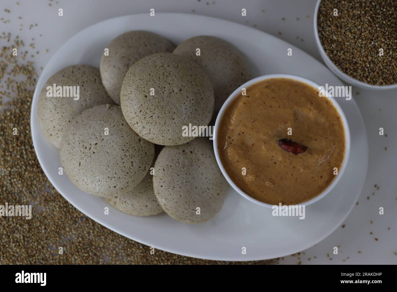 Bajra idly served with spicy coconut condiment. Steamed savory rice ...