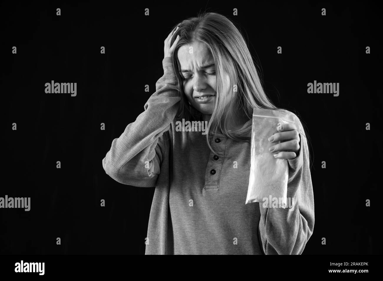 Young female junkie with drugs on black background Stock Photo - Alamy