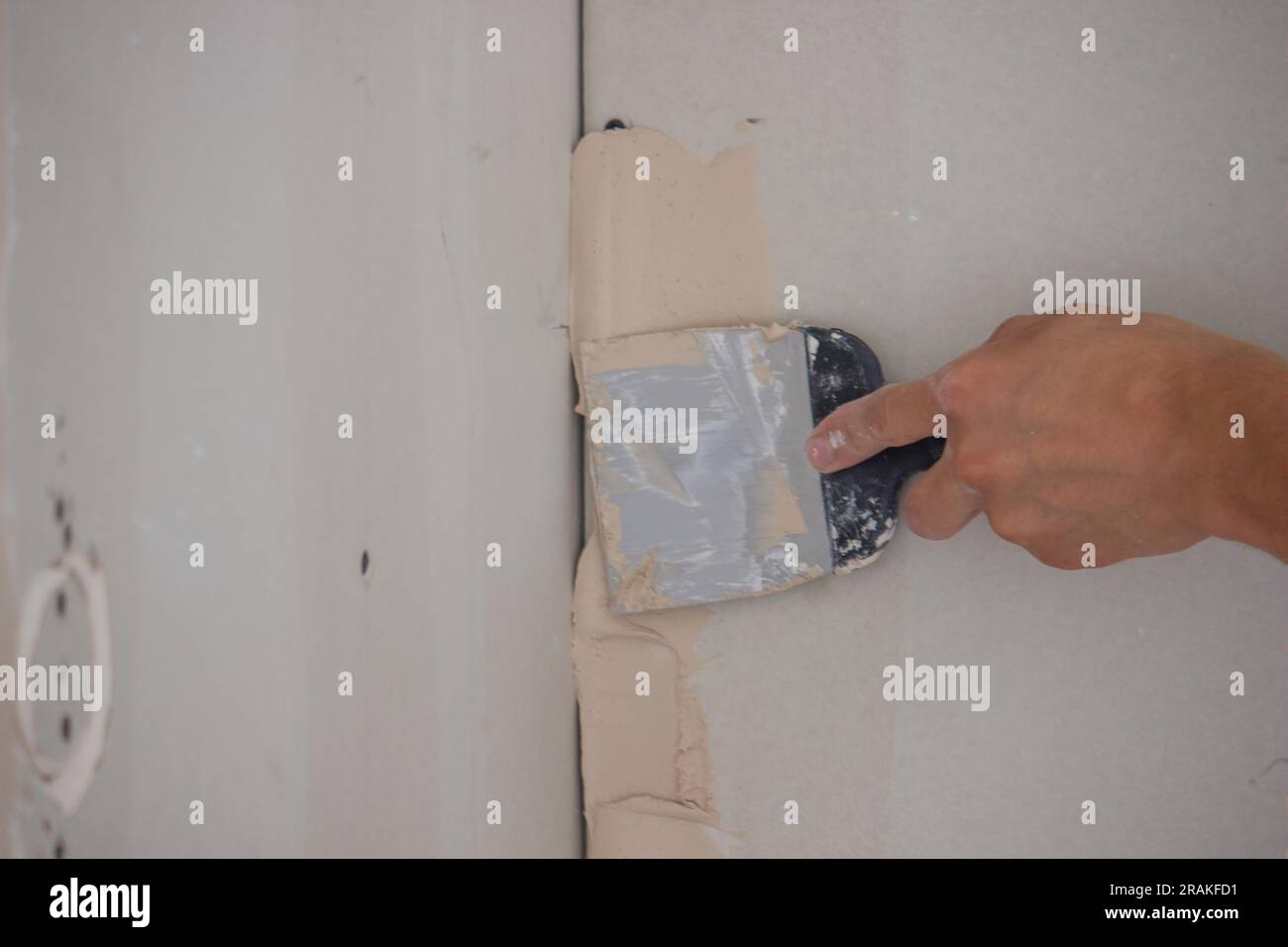 Worker plasters wall spatula hi-res stock photography and images - Alamy