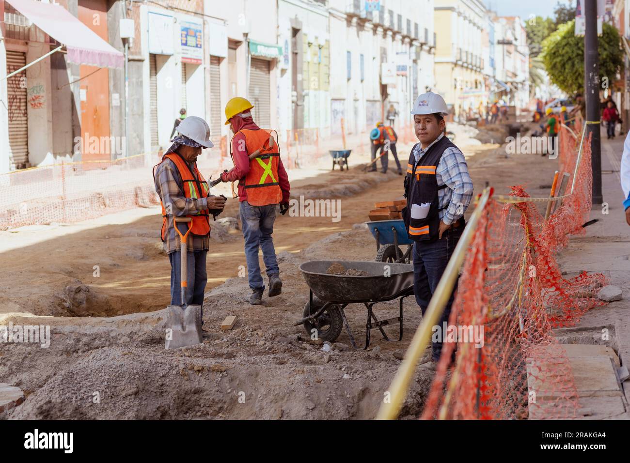 Construction workers work to repair a street in the Historic Center of ...