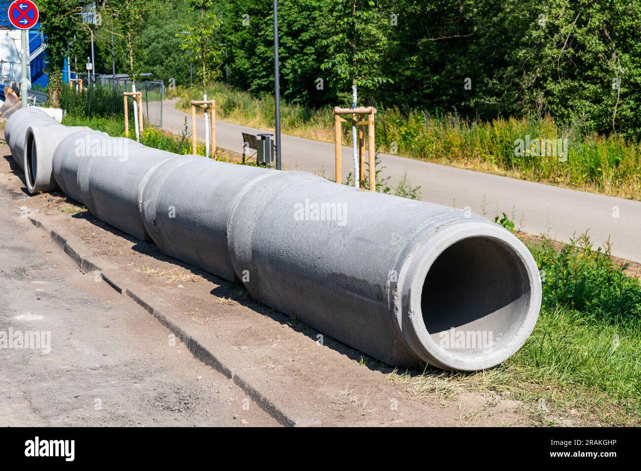 Gray concrete pipes for plumbing and drainage lying on the edge of a ...