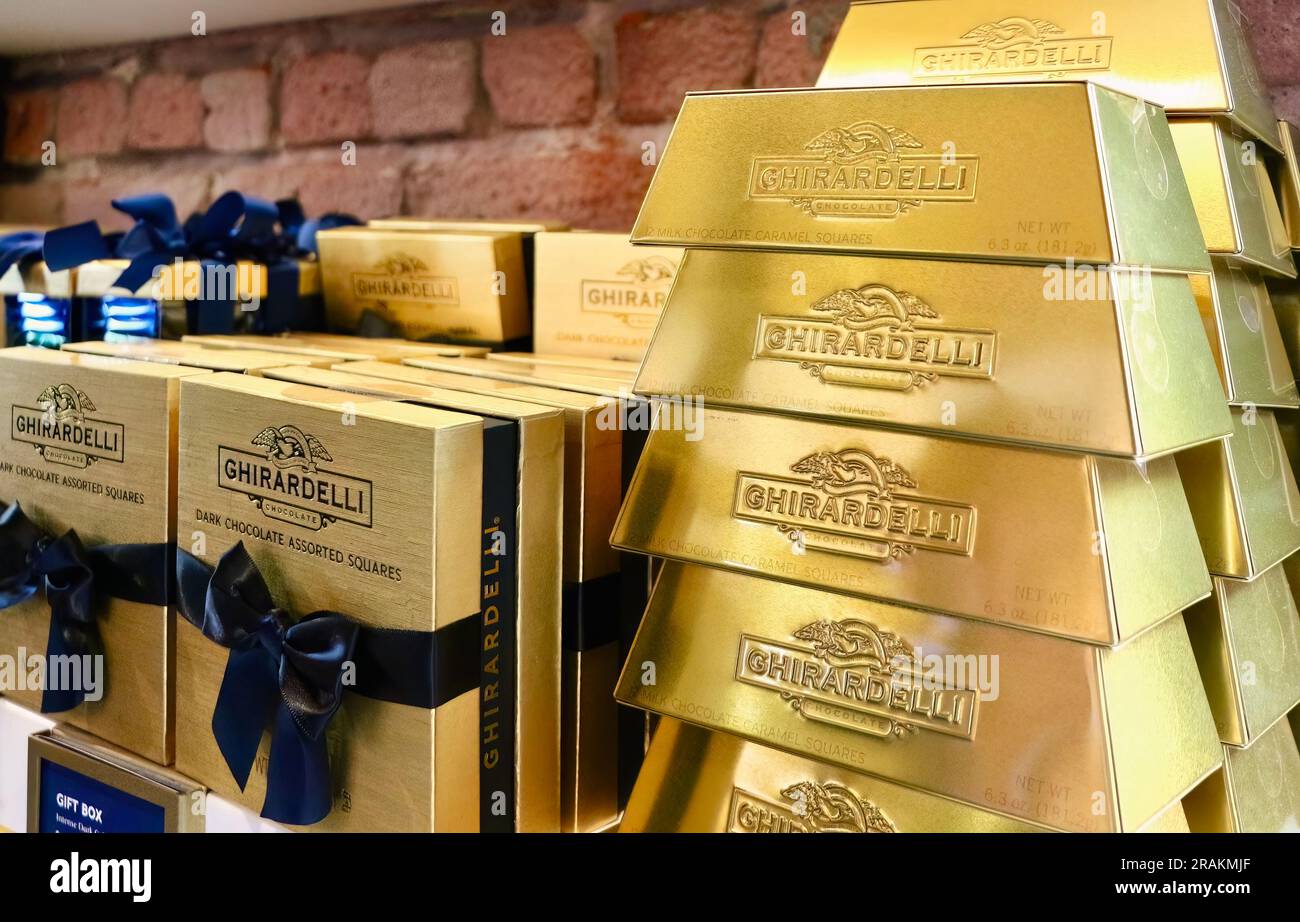 Shop shelf with stacked gold chocolate bars and boxes inside the shop ...