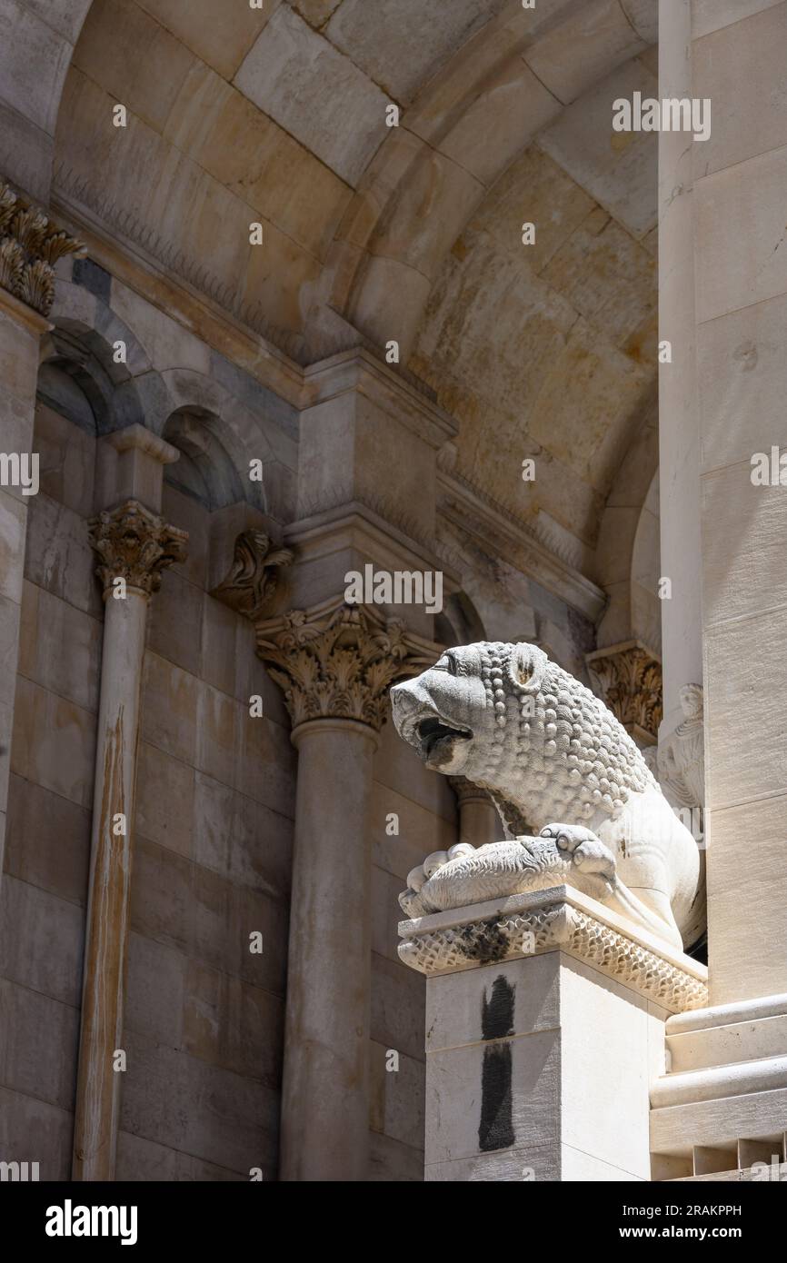 A sculpture of a lion on the entrance steps to the Cathedral of Saint ...