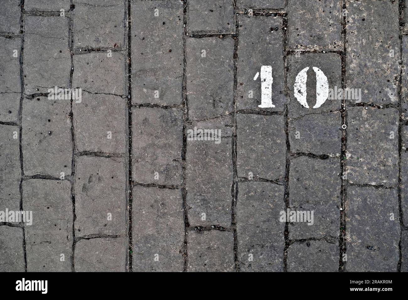 10, number ten, white stencil number on cobblestone surface Stock Photo ...