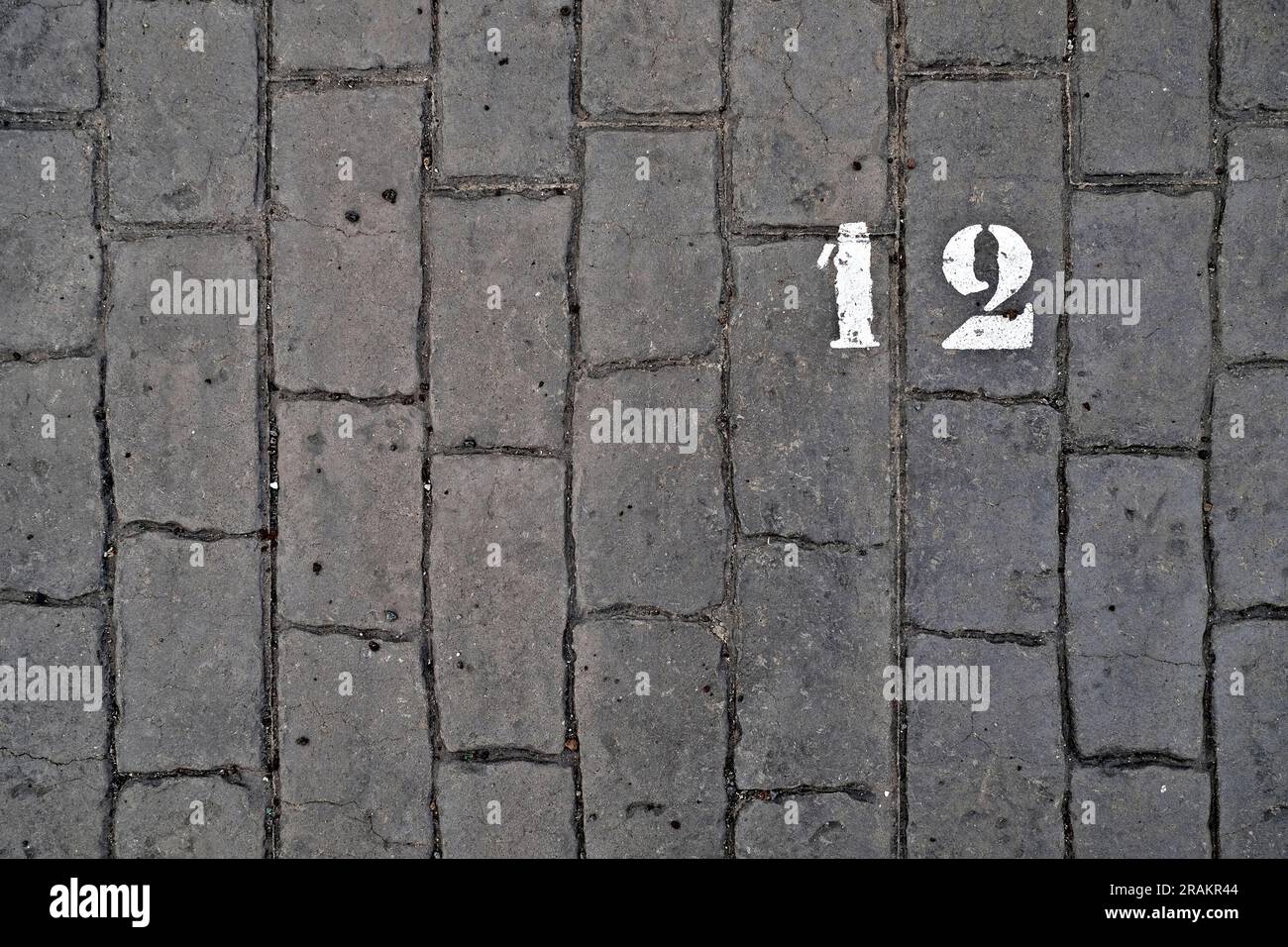 12, number twelve, white stencil number on cobblestone surface Stock ...
