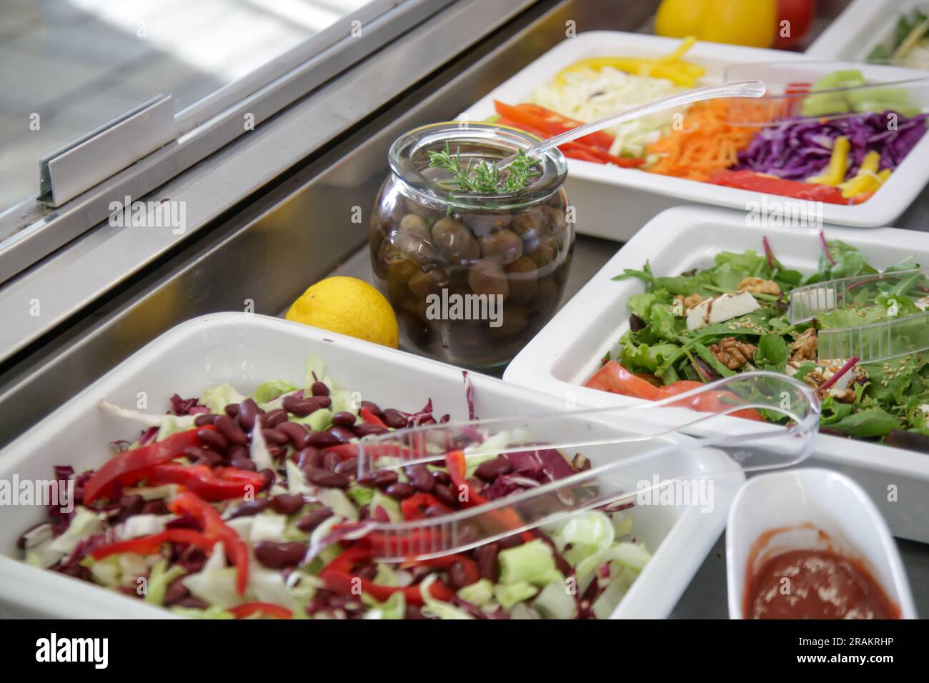 Various fresh salads served on a buffet line, healthy meal option Stock ...