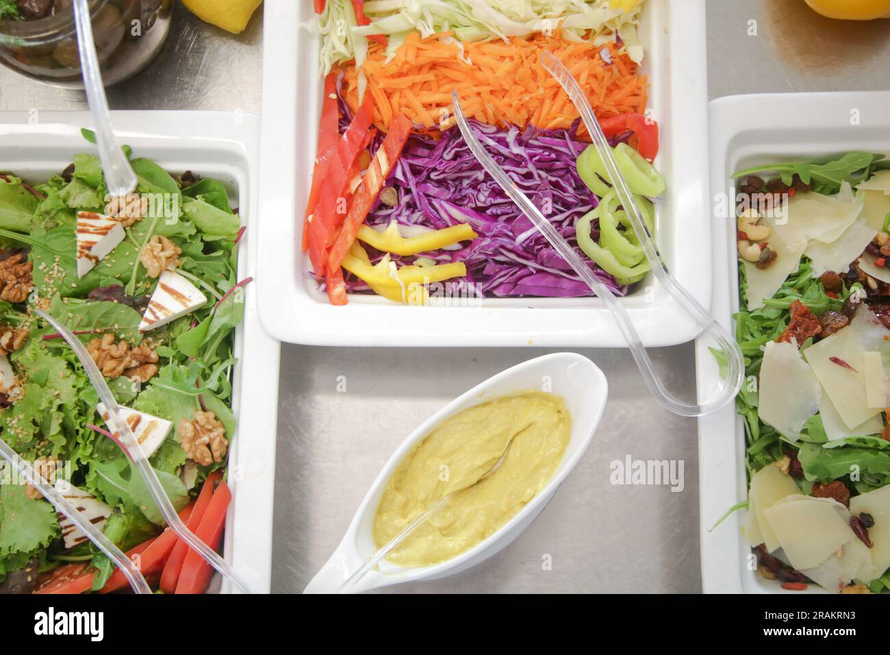 Various fresh salads served on a buffet line, healthy meal option Stock ...