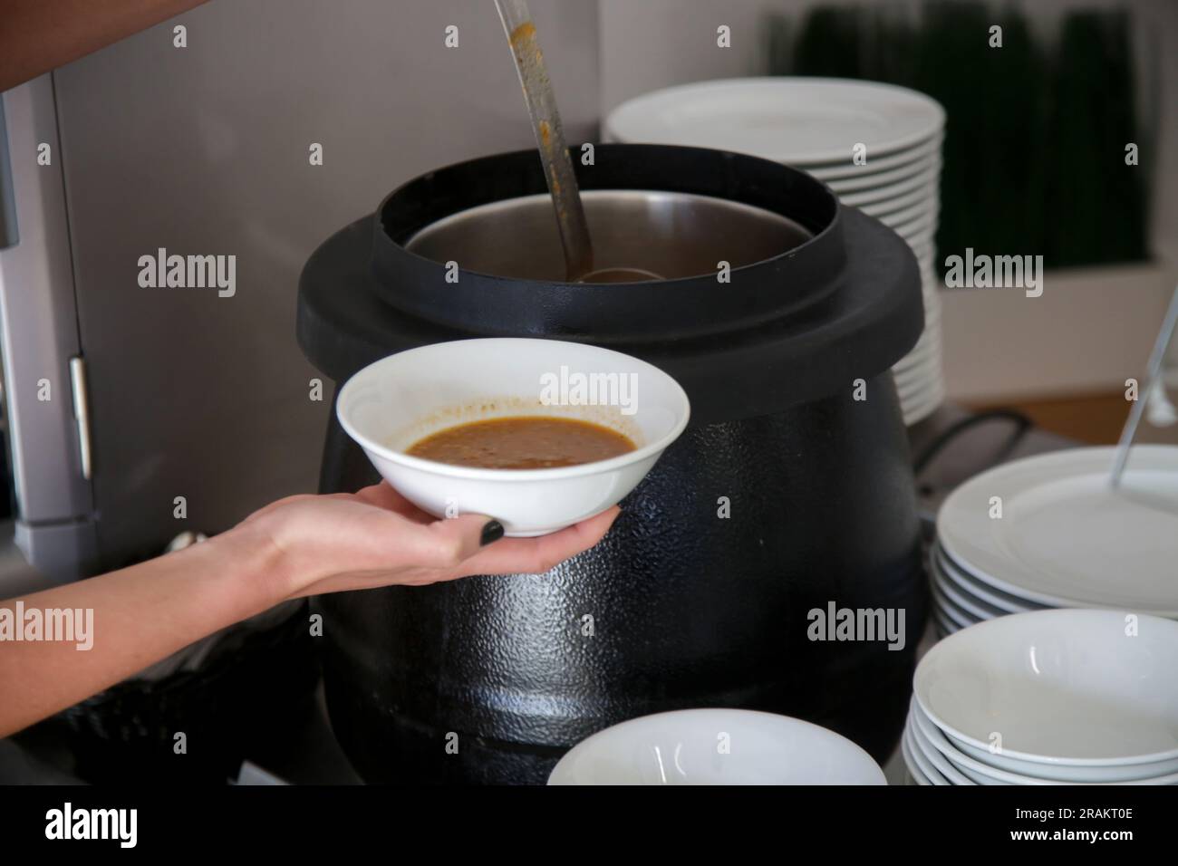 Woman taking soup from a buffet line Stock Photo - Alamy
