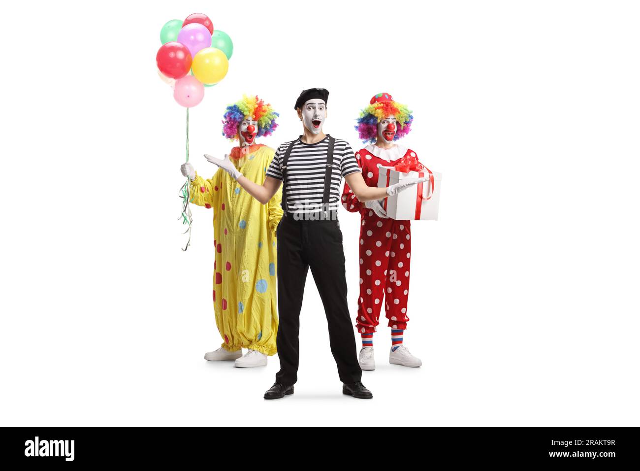 Full length portrait of two clowns and a mime posing isolated on white ...
