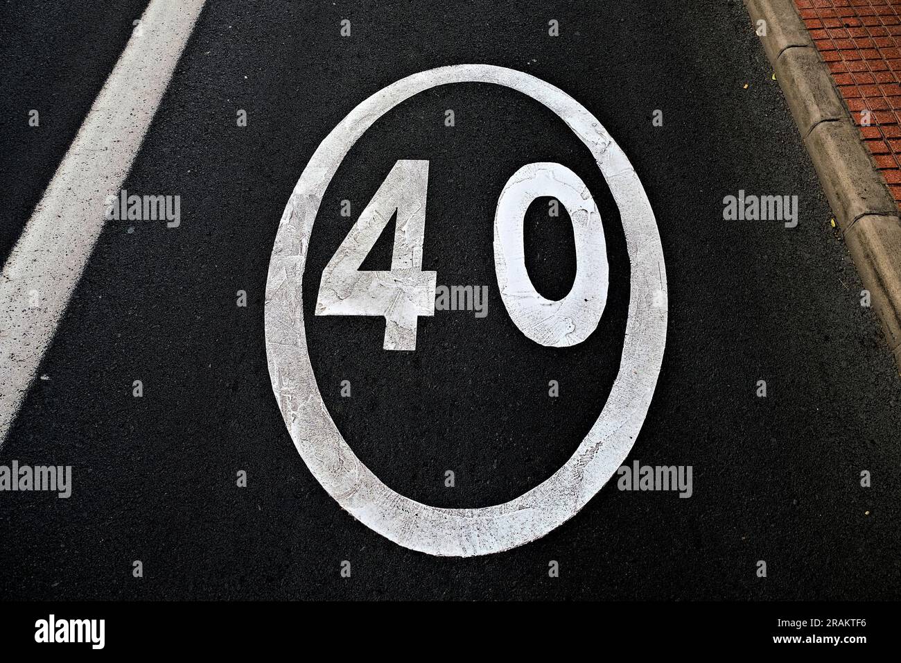 Forty, number 40, speed limit information painted in white reflective ...